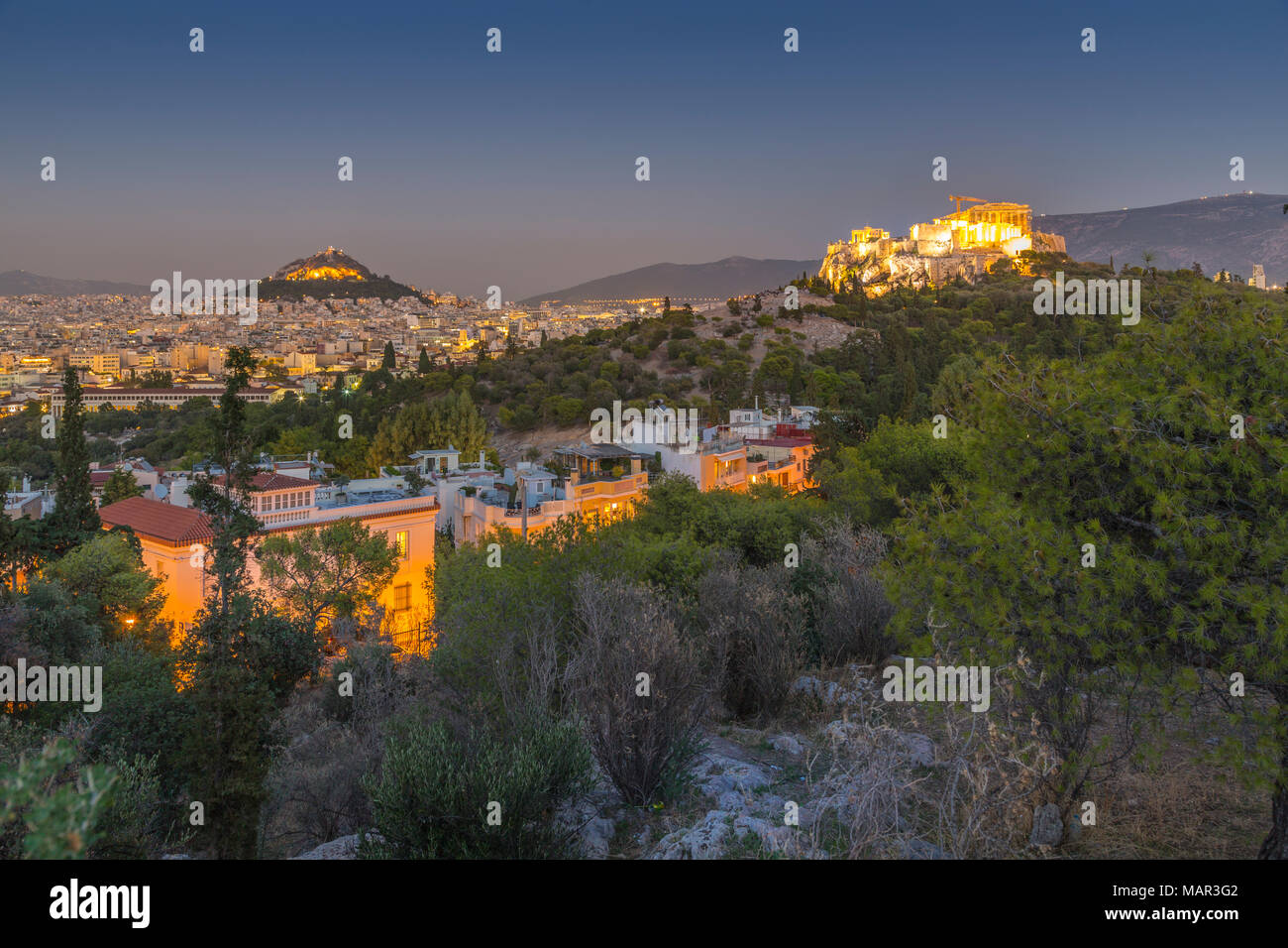 View of The Acropolis and Likavitos Hill at dusk from Filopappou Hill ...
