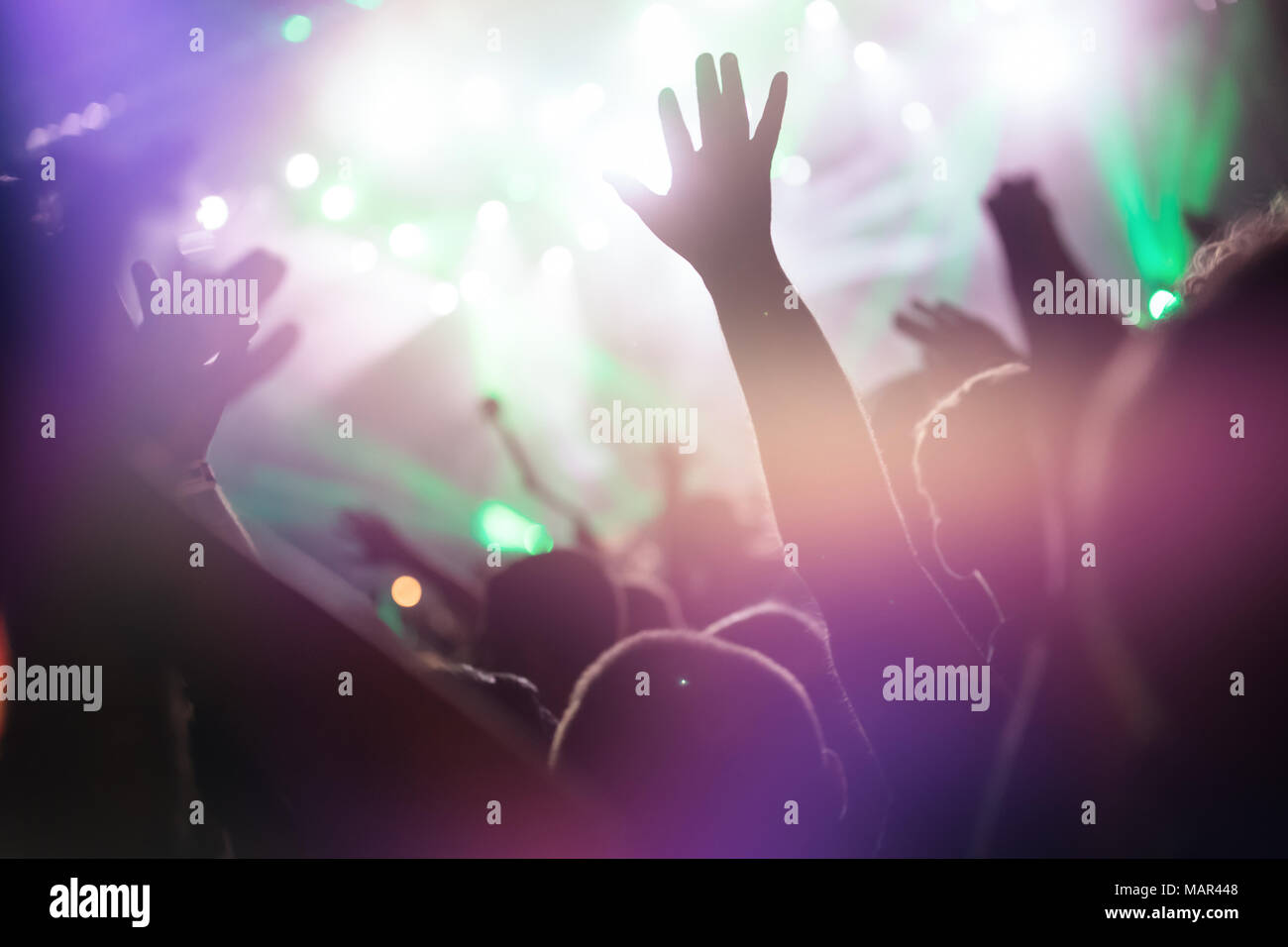 Cheering crowd at concert enjoying music performance Stock Photo - Alamy