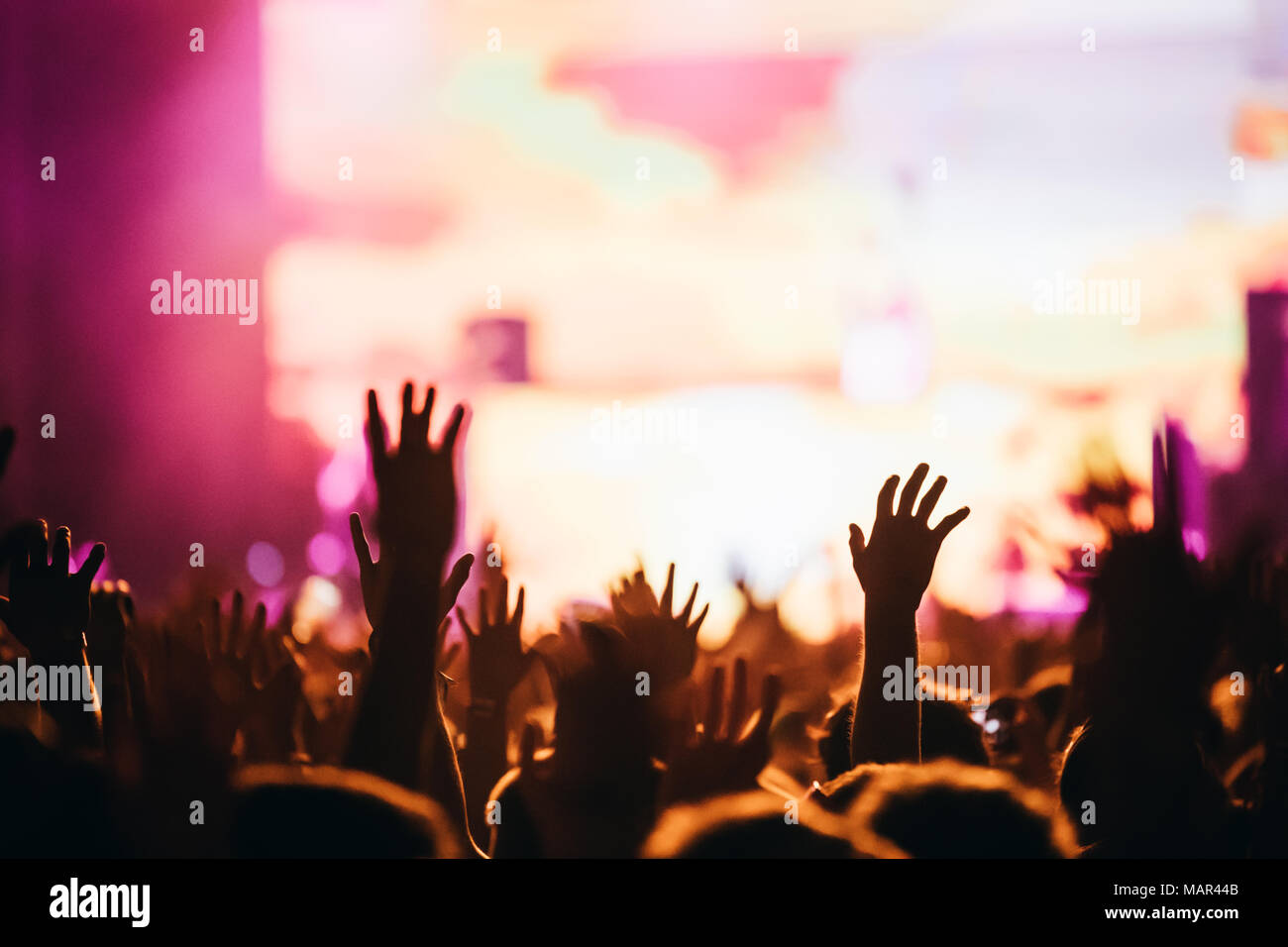Cheering crowd at concert enjoying music performance Stock Photo - Alamy