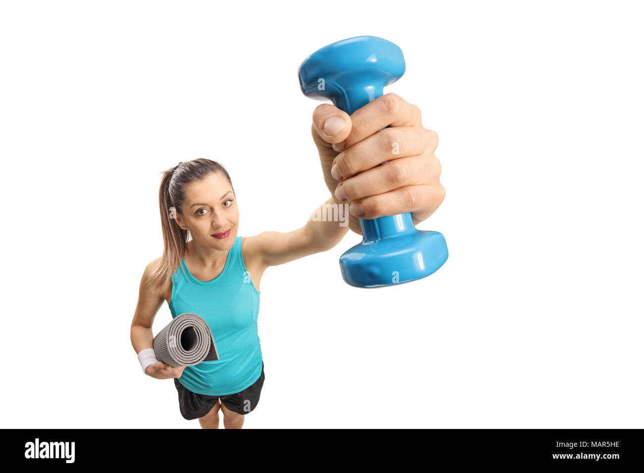 Fitness woman with an exercise mat and a dumbbell isolated on white ...