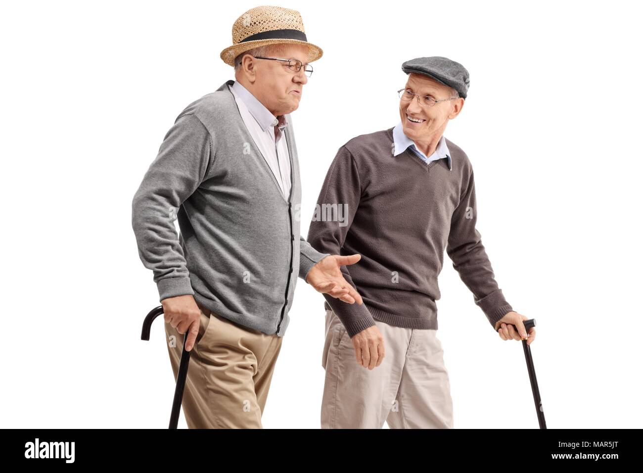Two mature men walking and talking to each other isolated on white ...