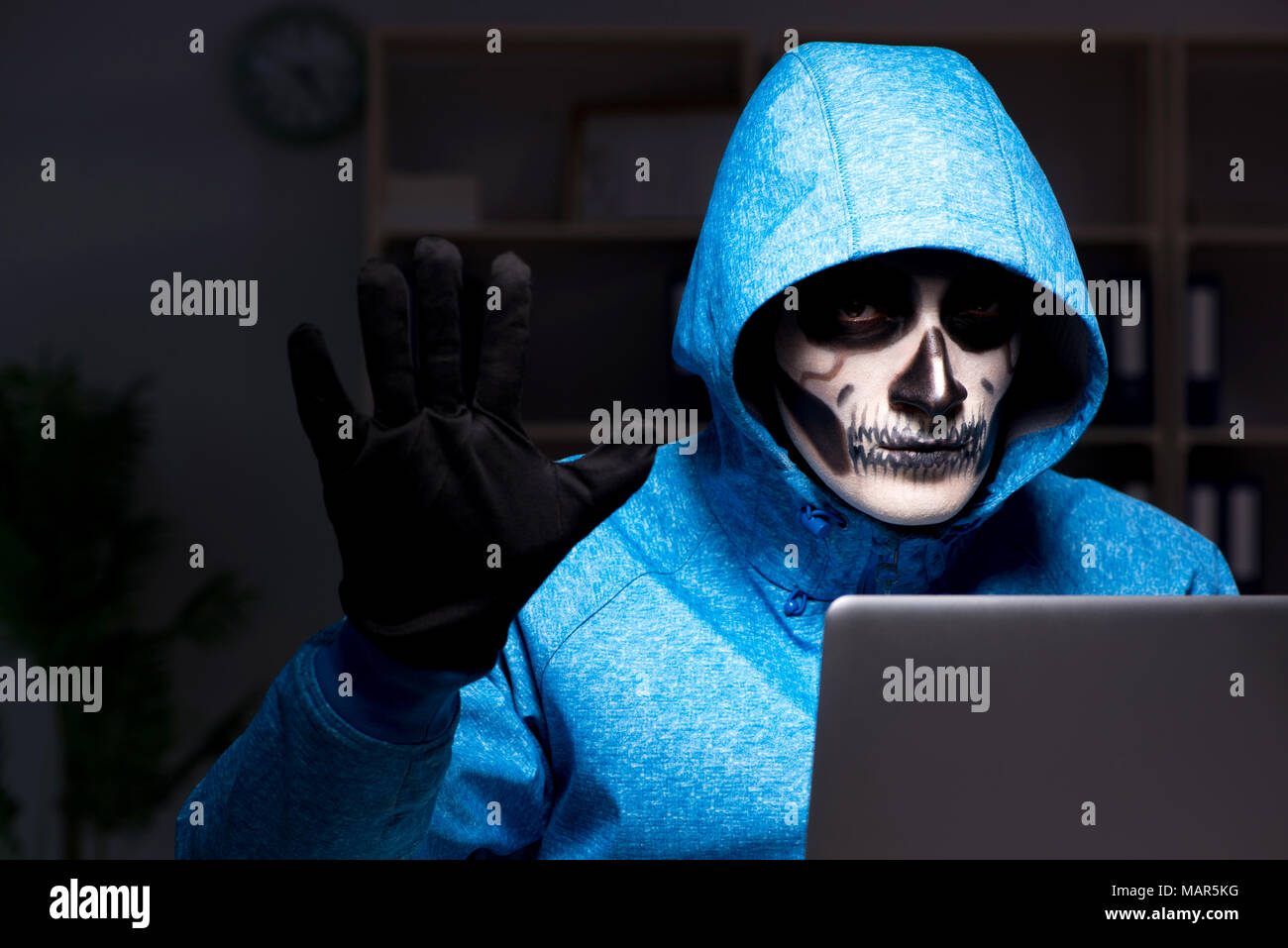 Scary hacker hacking security firewall late in office Stock Photo - Alamy