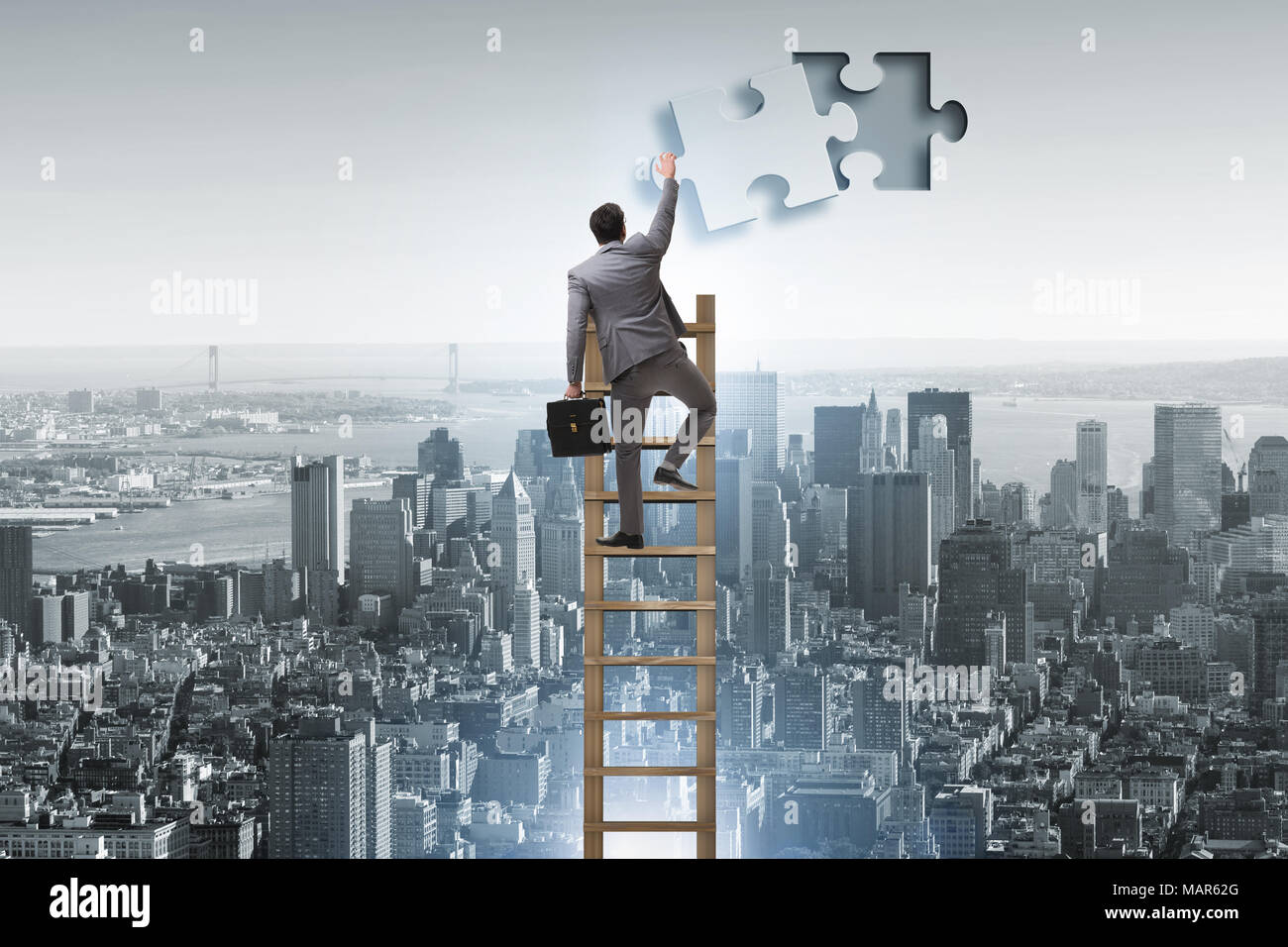Businessman putting together jigsaw puzzle pieces Stock Photo - Alamy