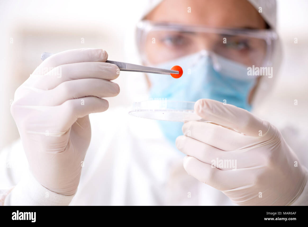 Lab assistant in drug synthesis concept Stock Photo - Alamy