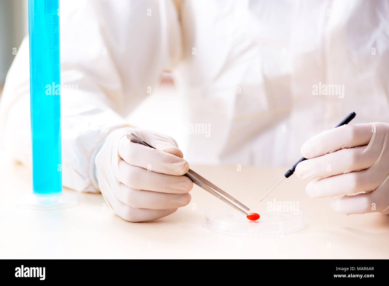 Lab assistant in drug synthesis concept Stock Photo - Alamy