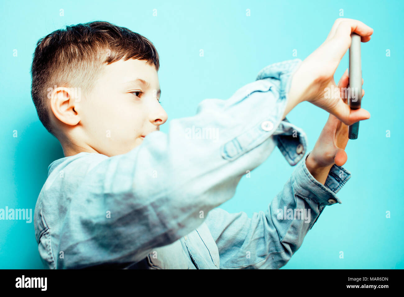 little cute boy posing emotional on blue background with smartph Stock ...
