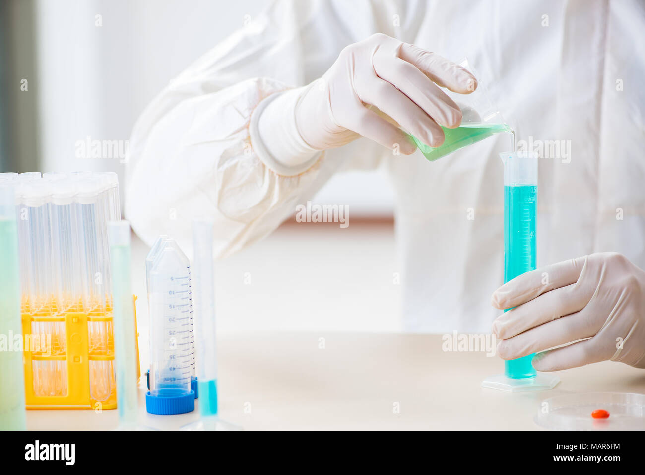 Young chemist student working in lab on chemicals Stock Photo - Alamy