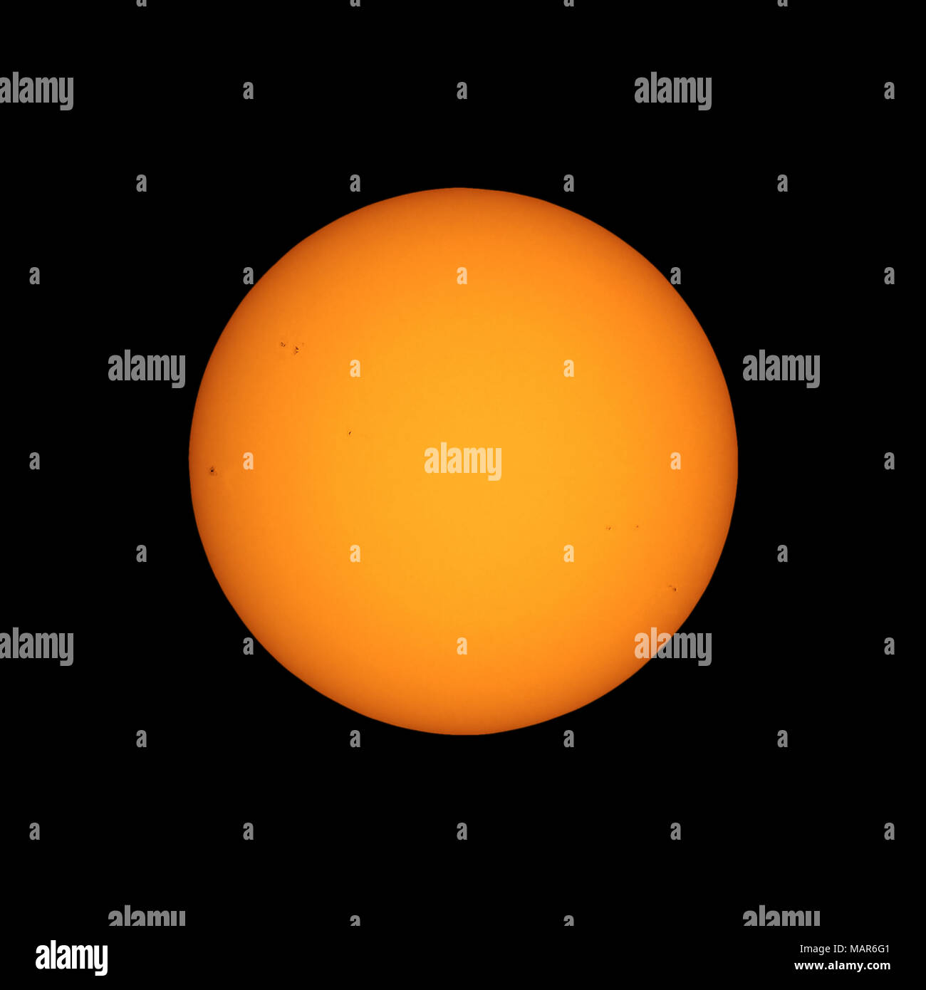 the Sun seen with telescope from planet Earth, with sunspots visible as ...