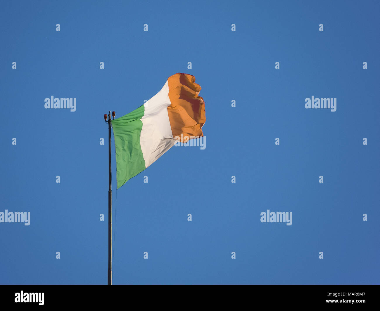 the Irish national flag of Ireland, Europe over blue sky Stock Photo ...