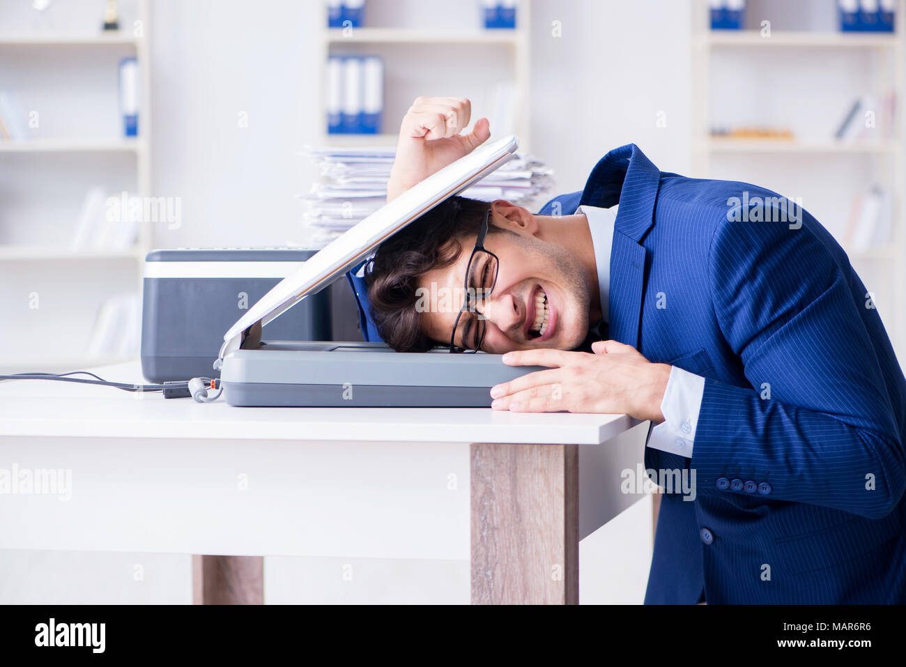 Businessman making copies in copying machine Stock Photo - Alamy