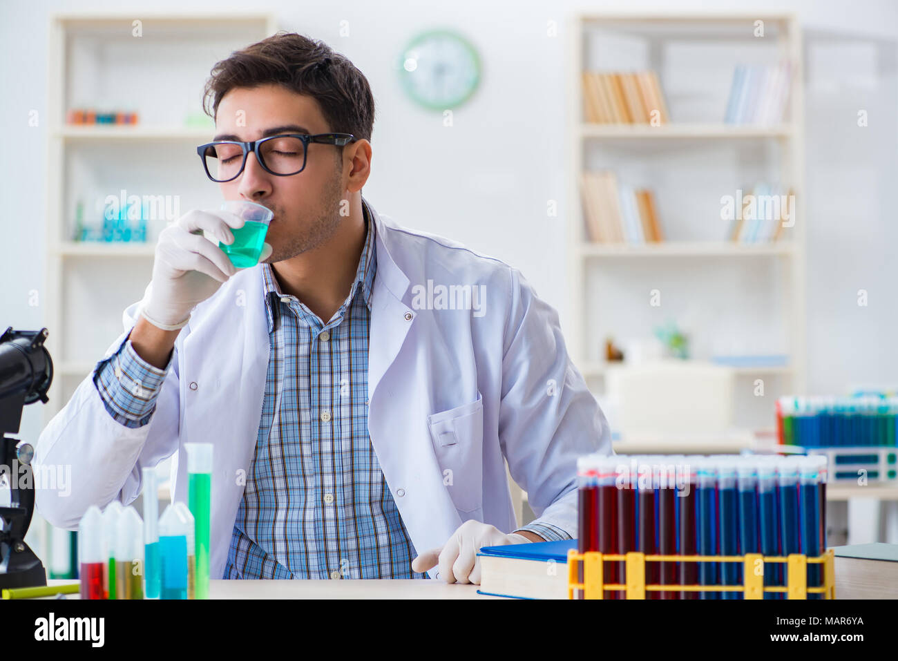 Young chemist student working in lab on chemicals Stock Photo - Alamy
