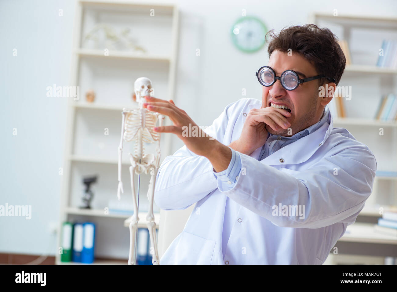 Crazy doctor studying human skeleton Stock Photo - Alamy