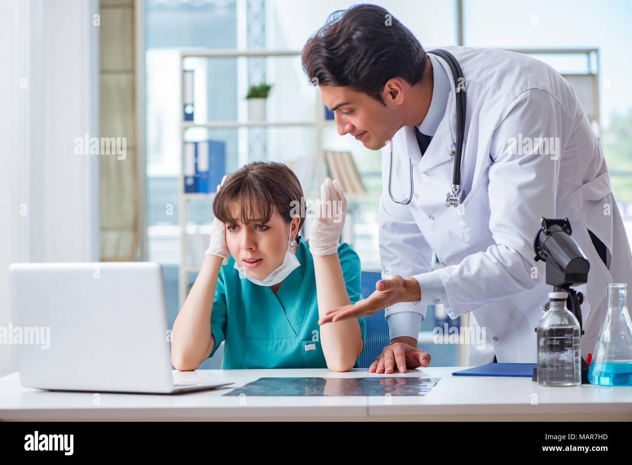 Doctor angry at his assistant due to medical error Stock Photo - Alamy