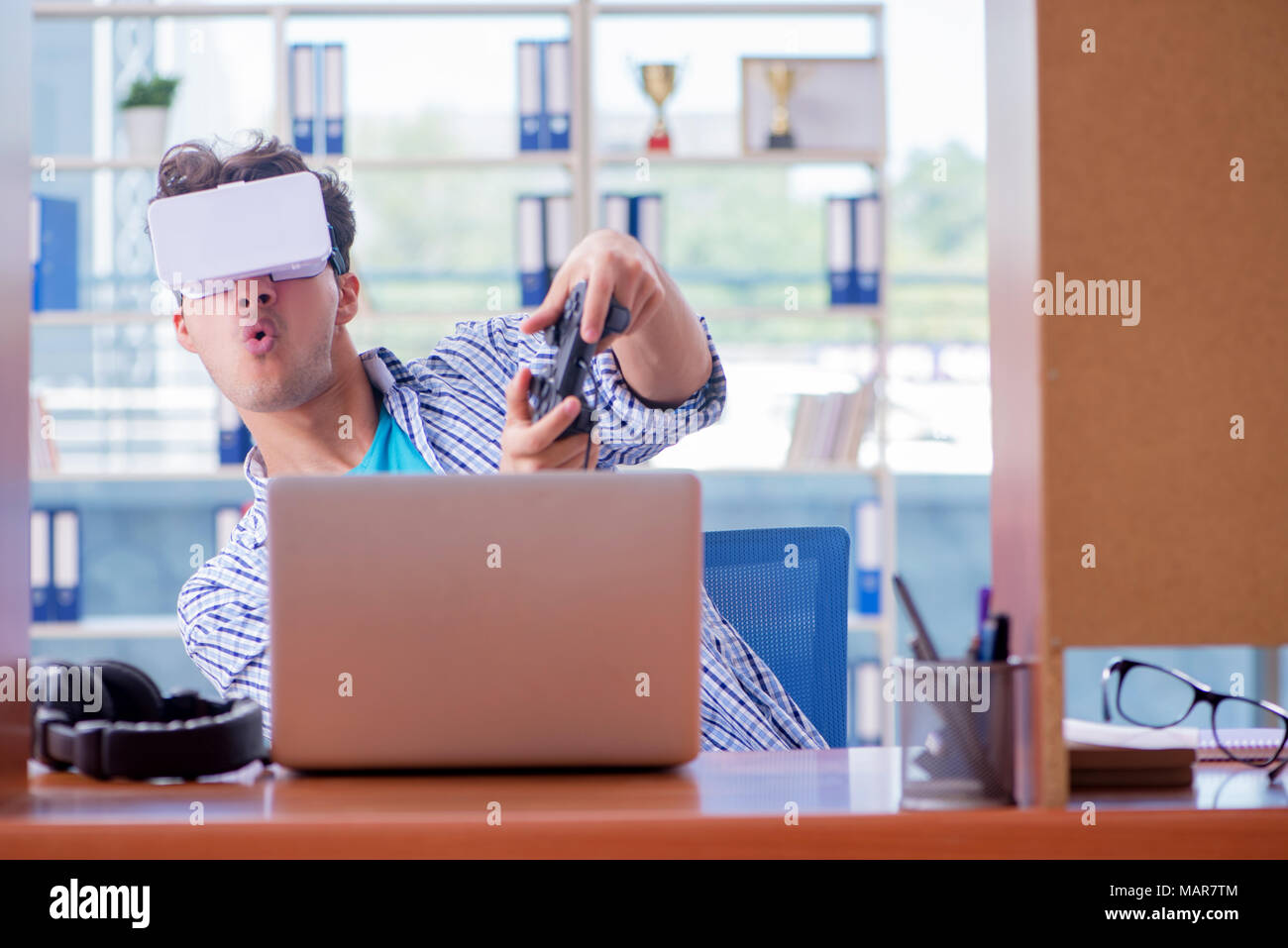 Young man playing computer game with virtual reality glasses Stock ...