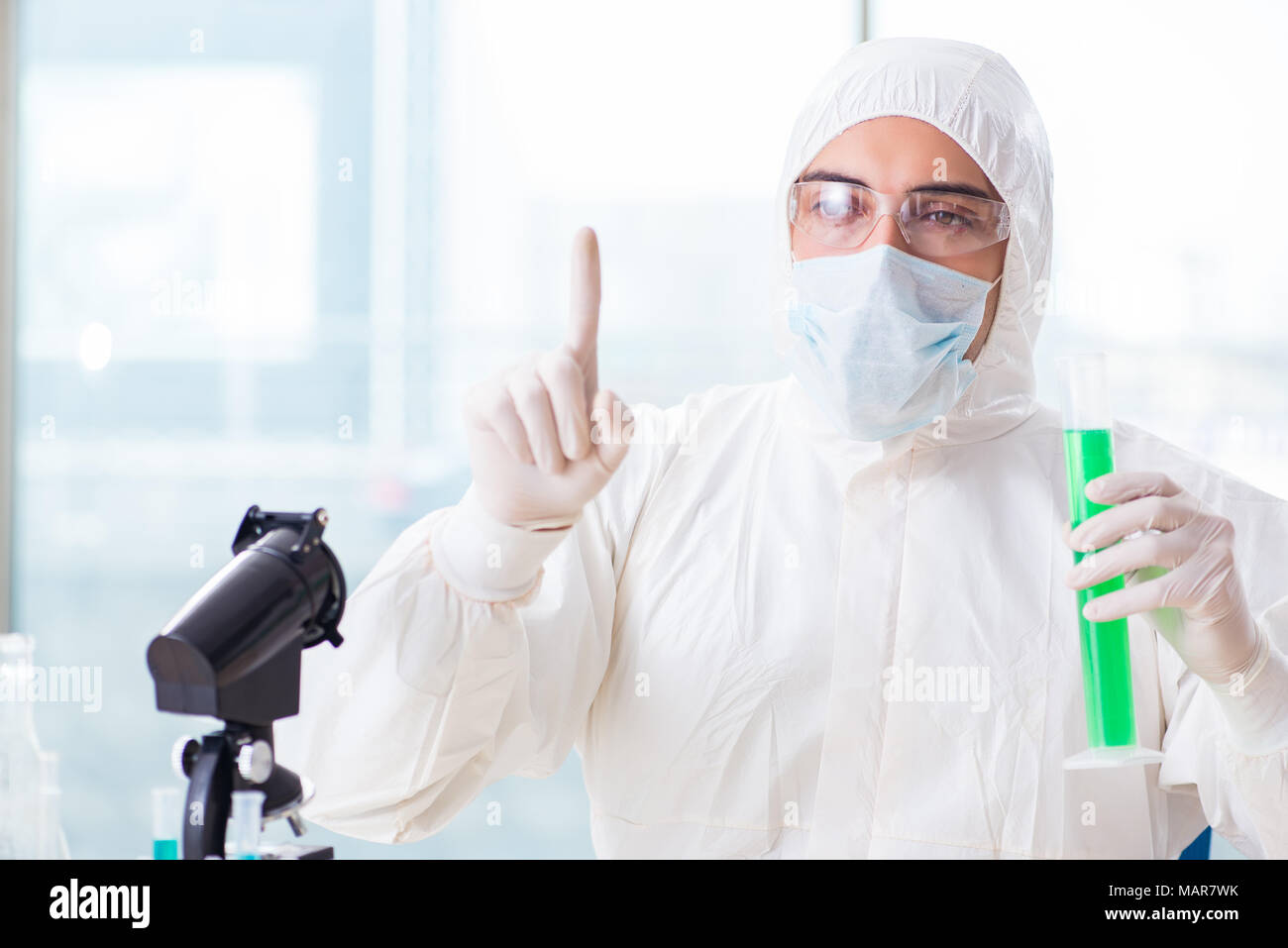 Young chemist pressing virtual buttons in lab Stock Photo - Alamy