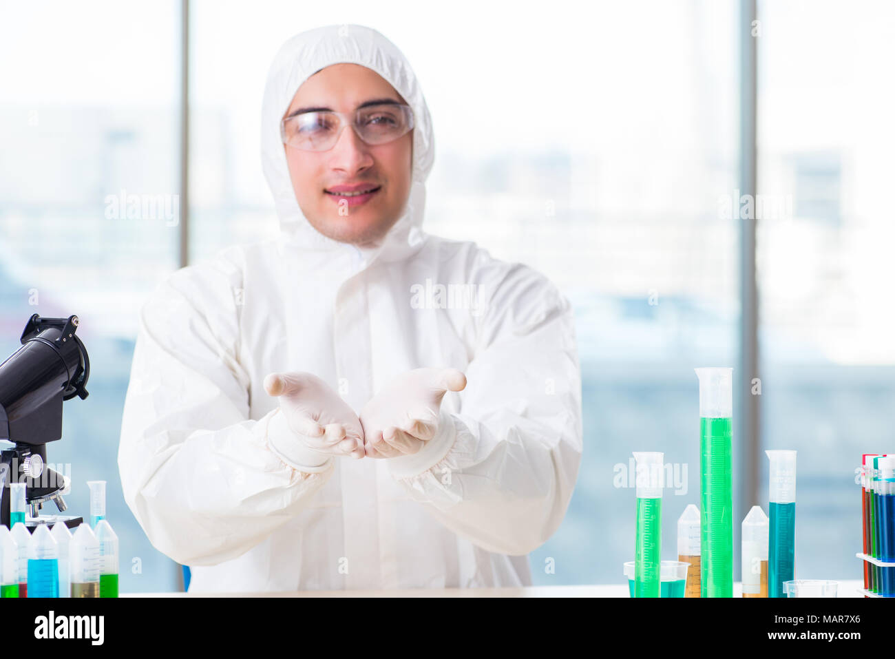 Young chemist student working in lab on chemicals Stock Photo - Alamy