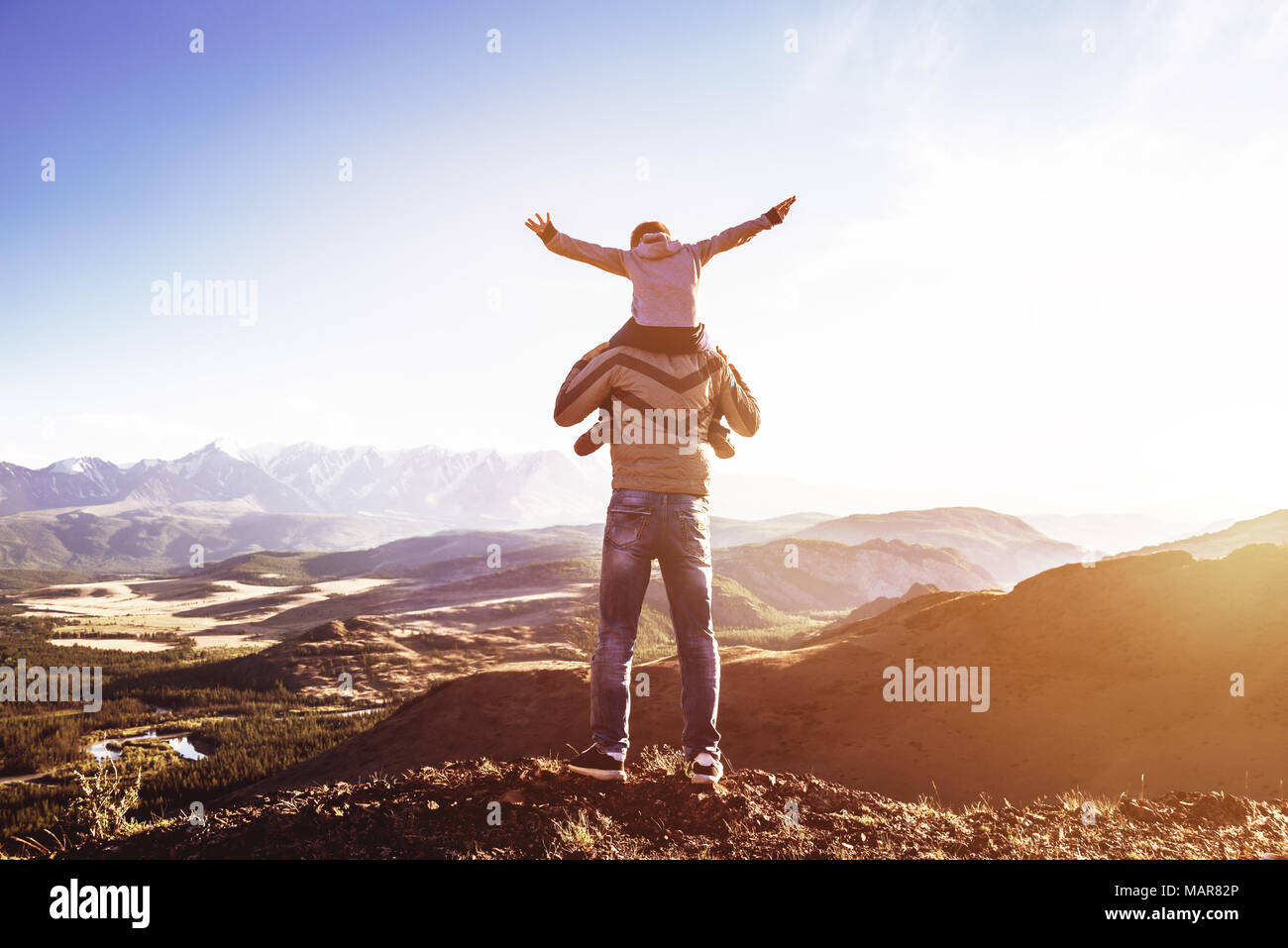 Father and son stands against mountains sunset and having fun. Fathers ...