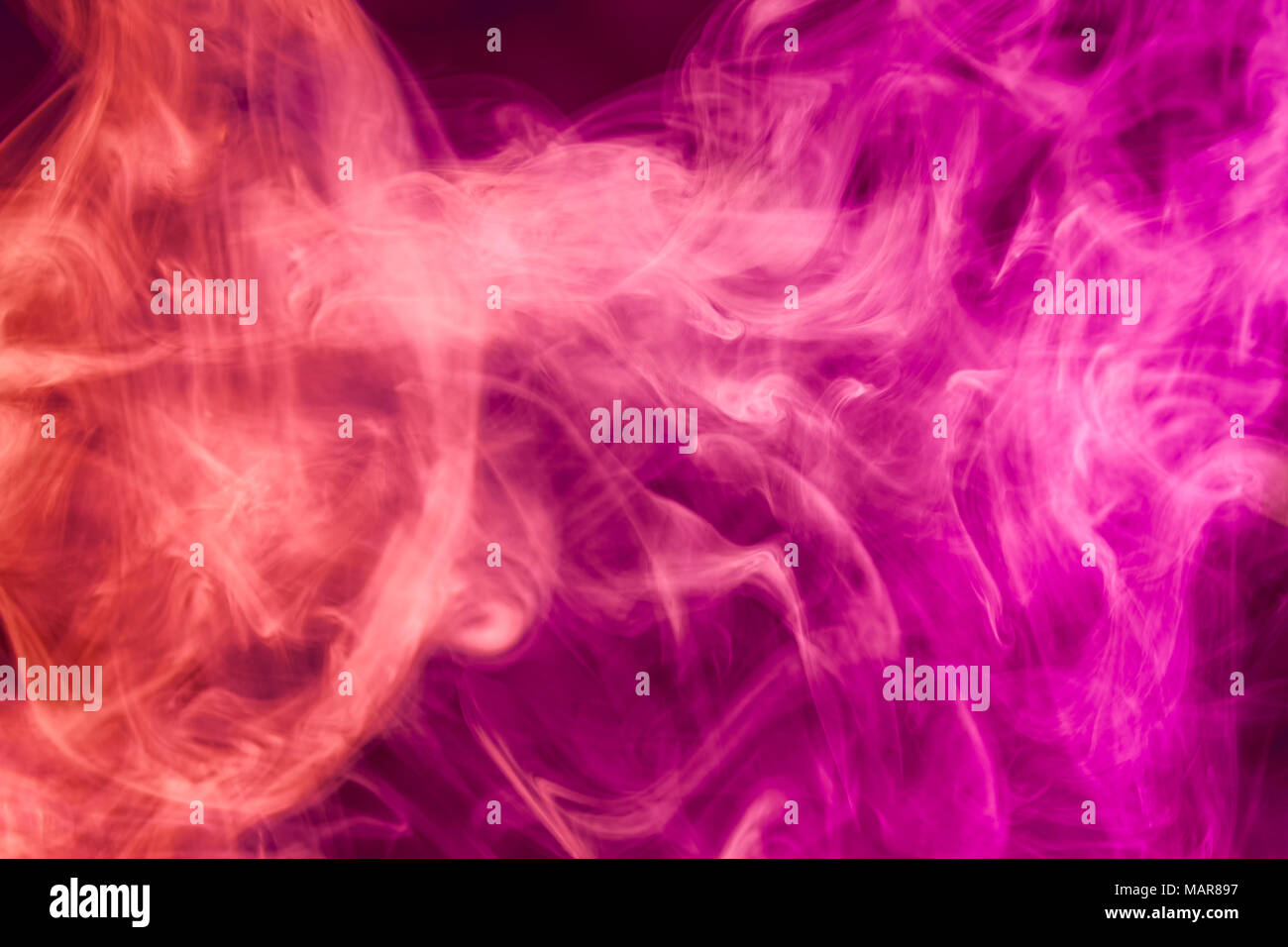 Colorful red and pink smoke on a black isolated background. Background ...