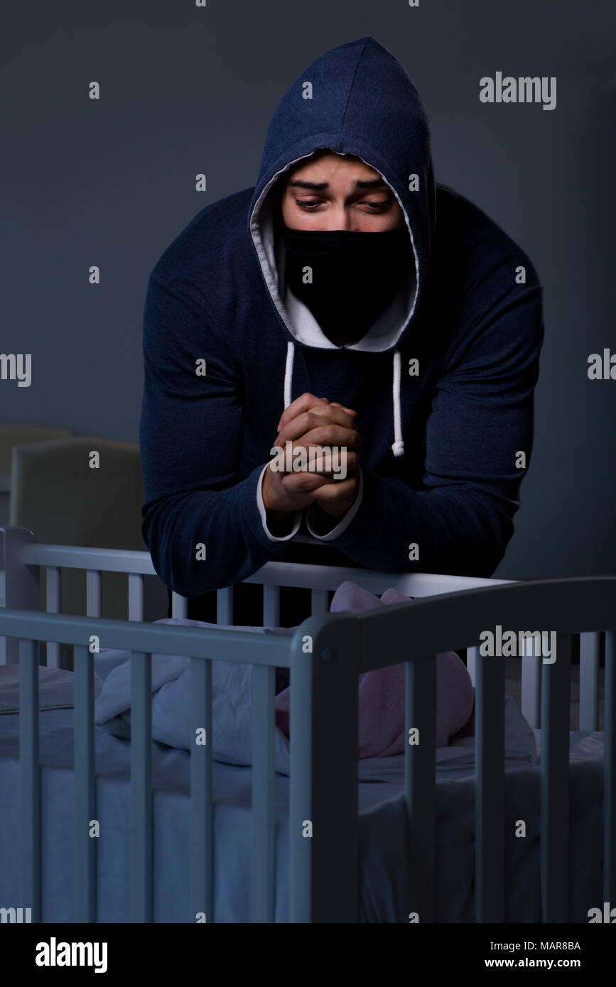 Criminal stealing baby in human child traficking concept Stock Photo ...
