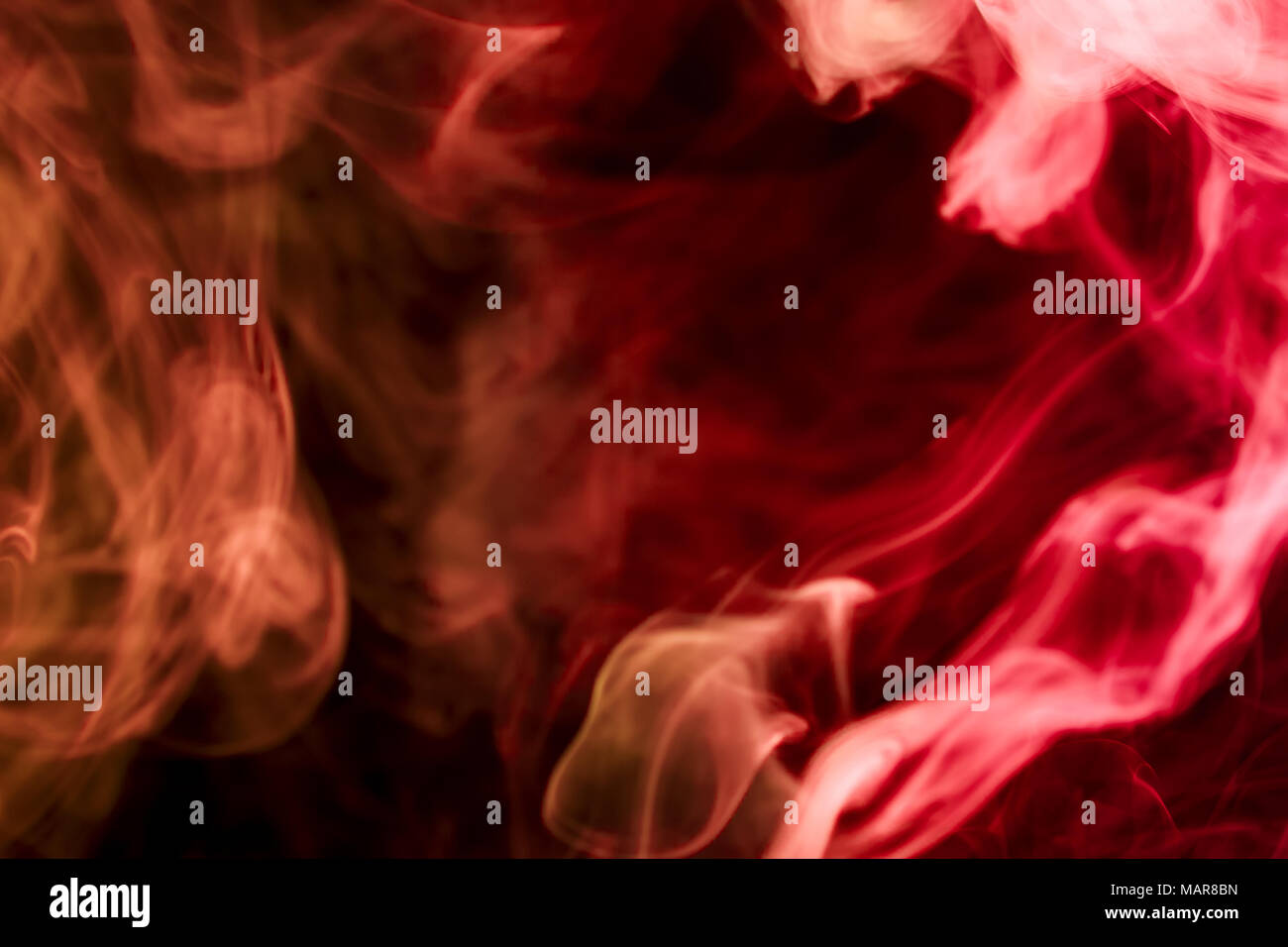 Colorful red and pink smoke on a black isolated background. Background ...