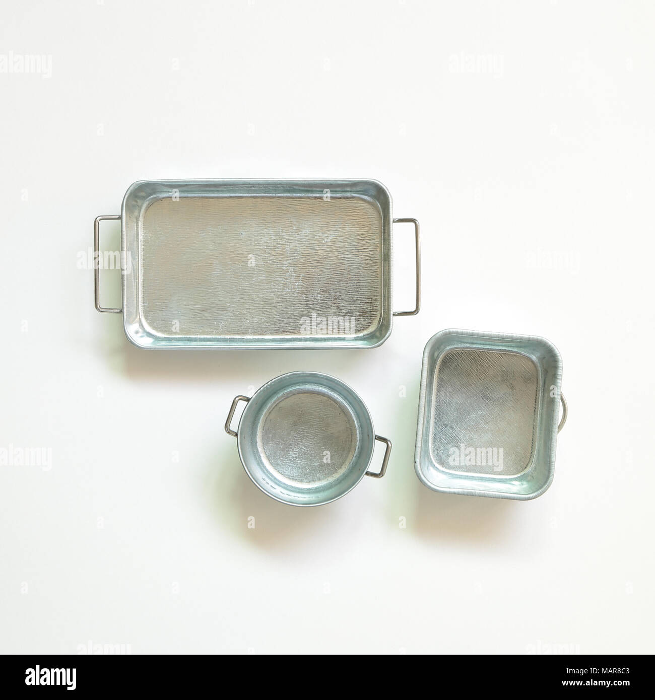 Metal dishes isolated on white background Stock Photo - Alamy