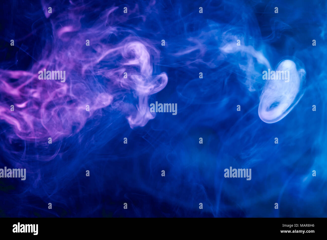 Thick colorful blue smoke on a black isolated background. Background ...