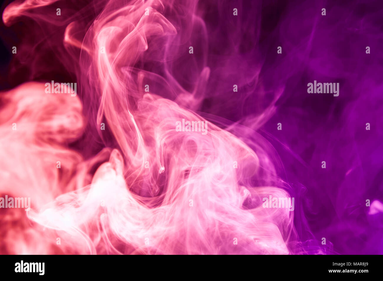 Thick colorful pink smoke on a black isolated background. Background ...