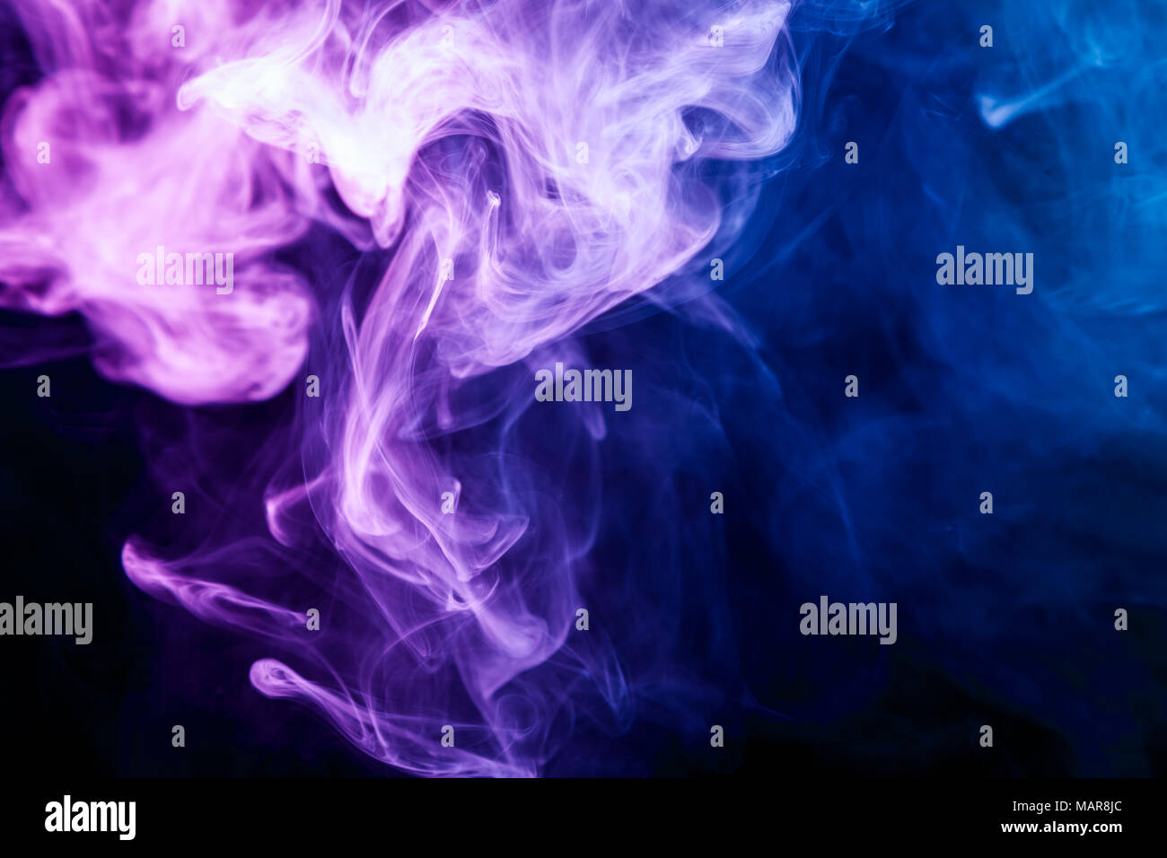 Thick colorful blue smoke on a black isolated background. Background ...