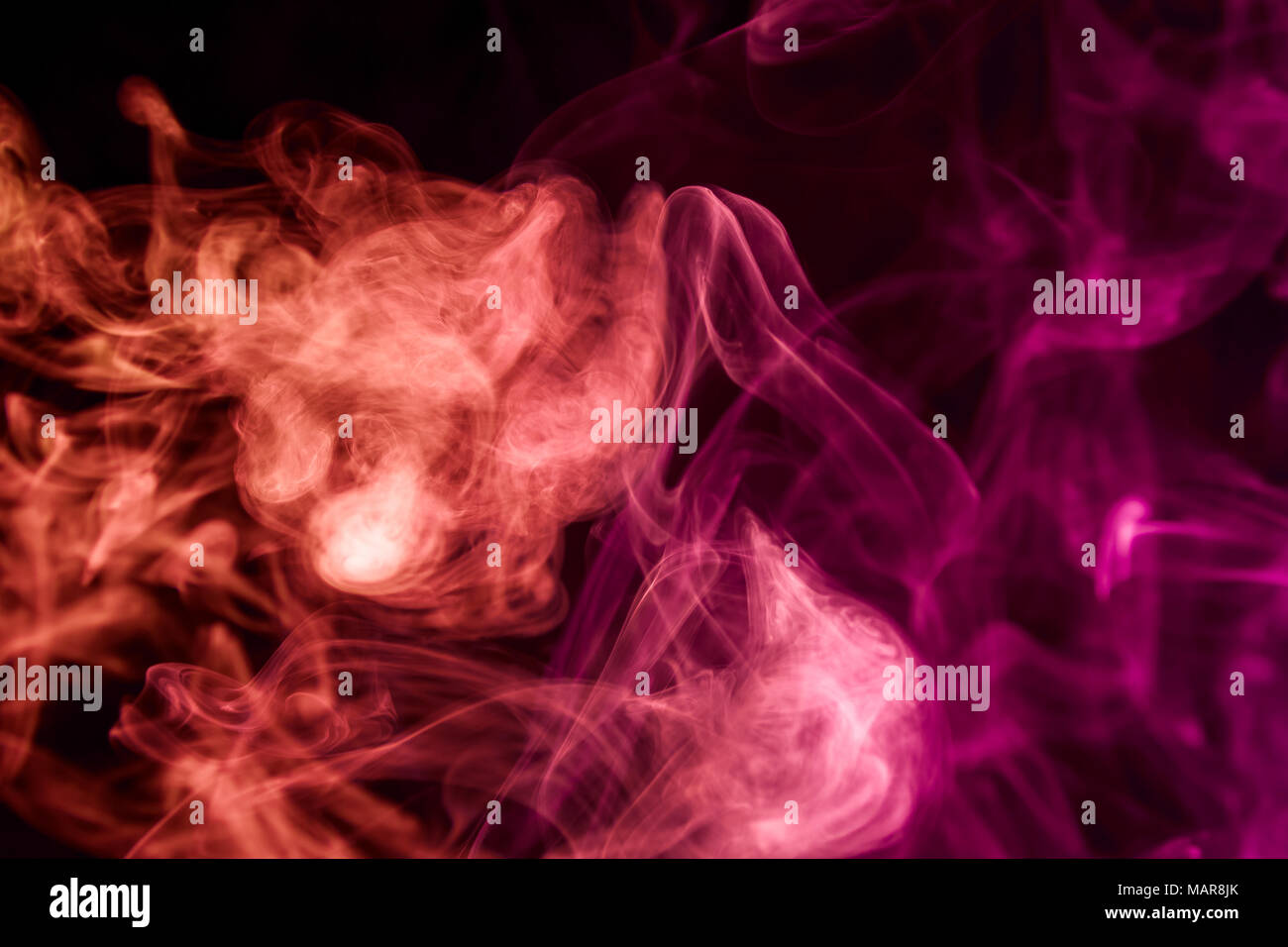 Red and pink smoke on black background Stock Photo - Alamy