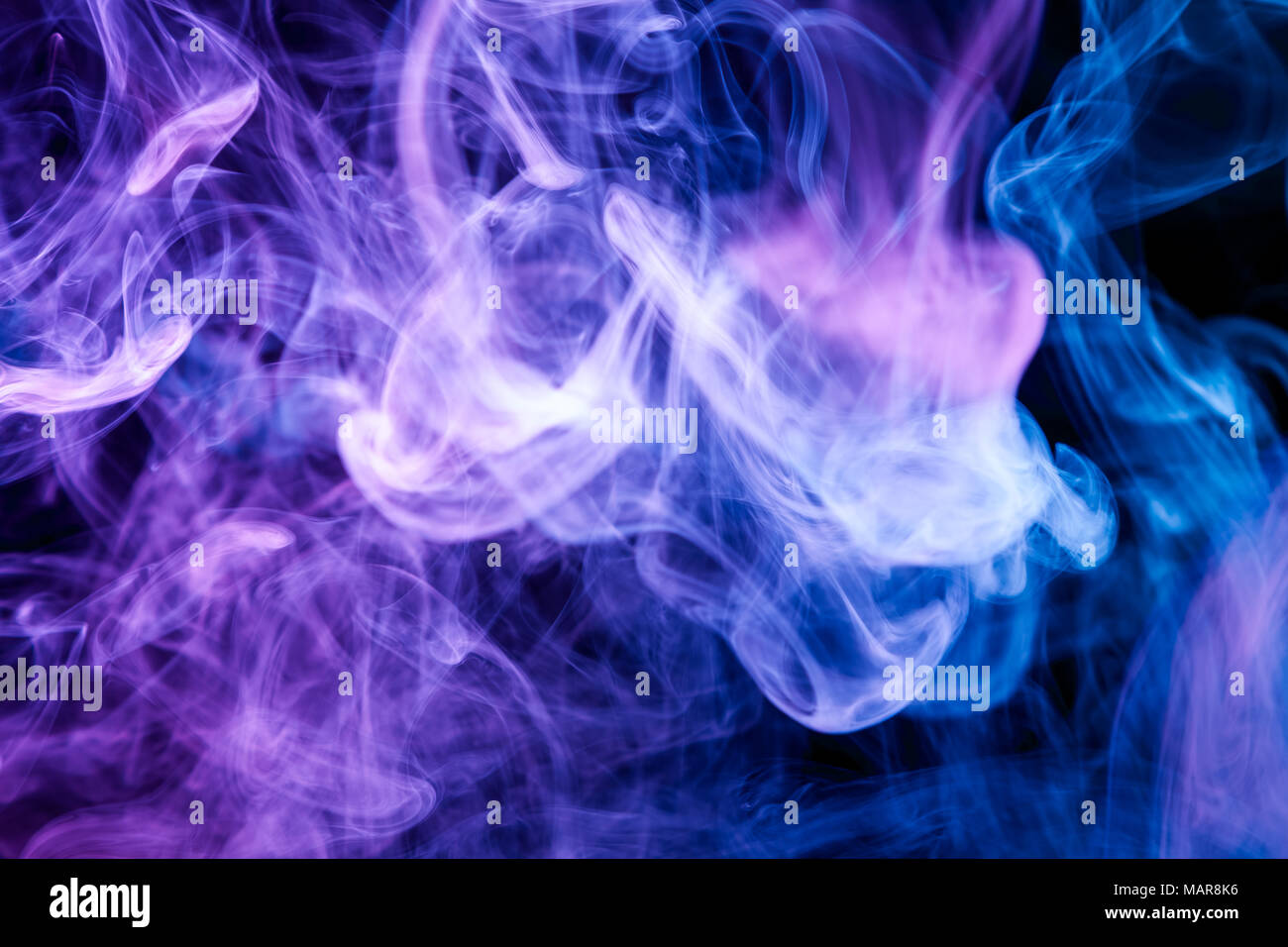 Thick colorful blue smoke on a black isolated background. Background ...