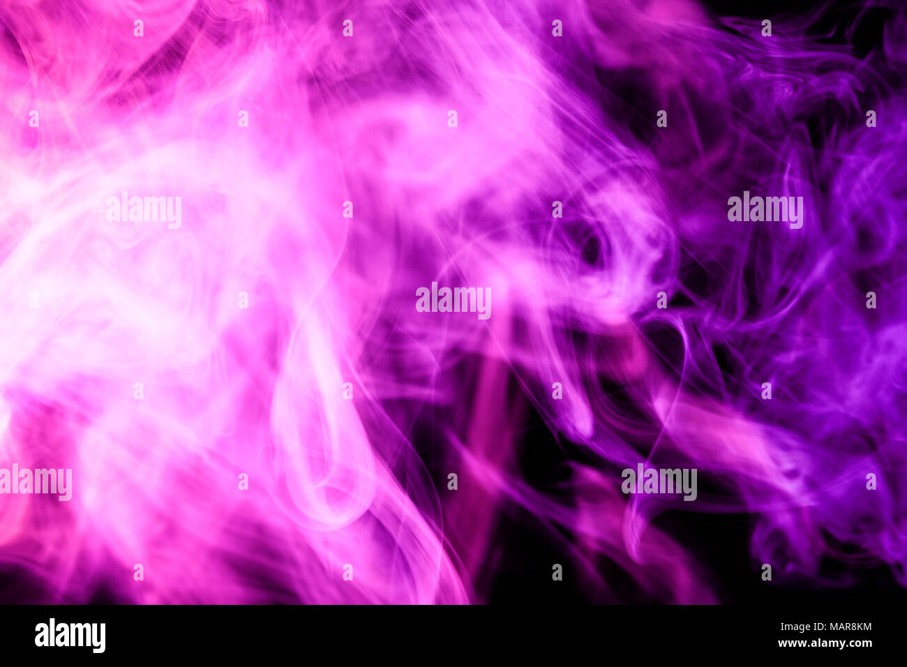 Thick colorful pink smoke on a black isolated background. Background ...