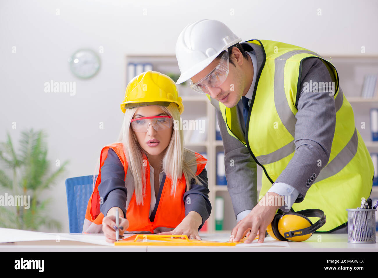 Construction workers having discussion in office before starting ...