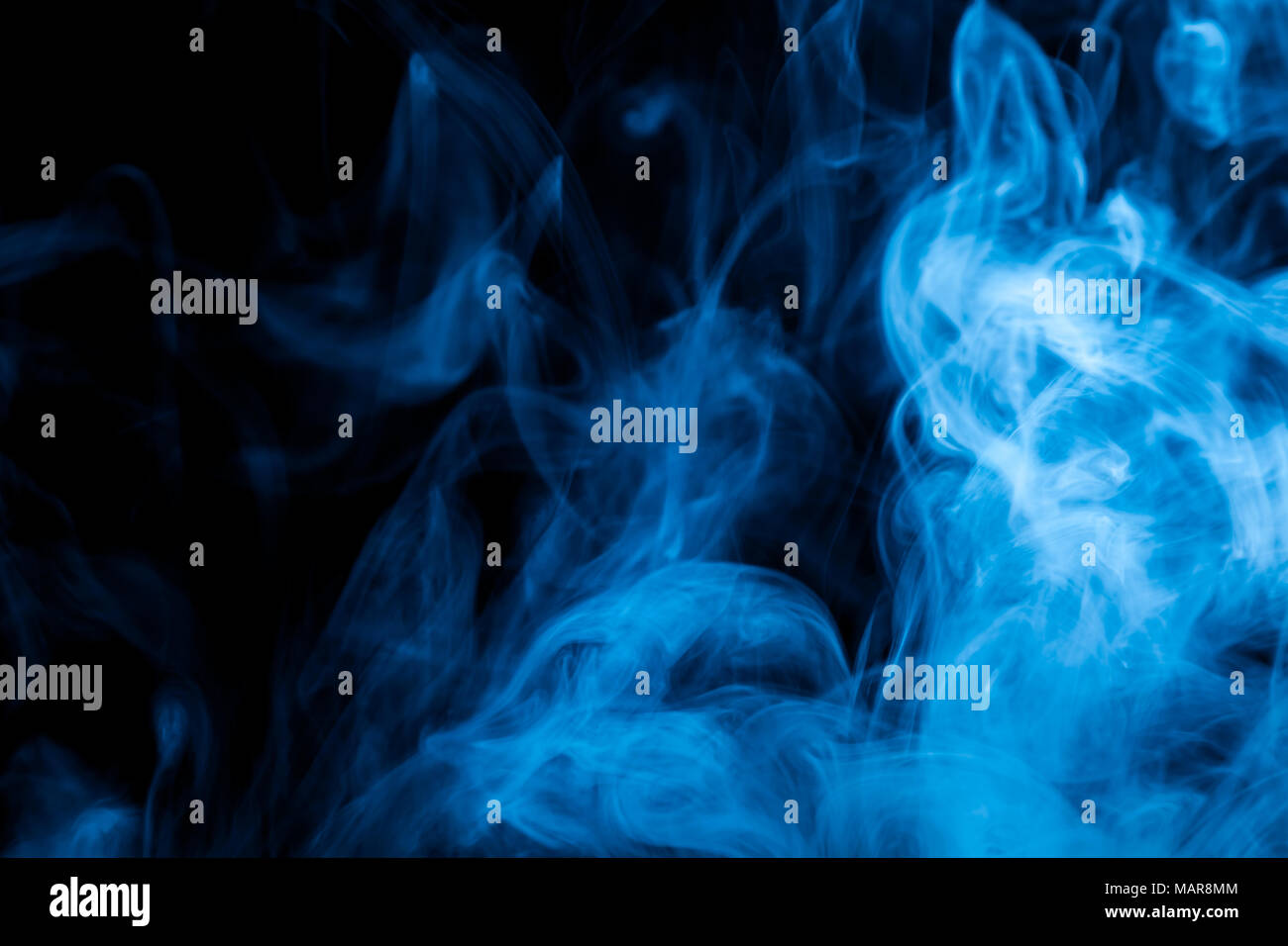Thick colorful blue smoke on a black isolated background. Background ...