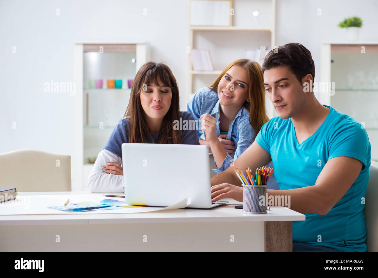Team of designers discussing new interior project Stock Photo - Alamy