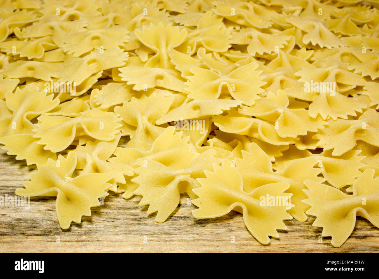 Noodles Farfalle butterflies on wooden background Stock Photo - Alamy