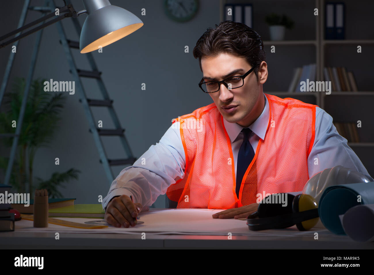 Construction architect working on drawings late at night Stock Photo ...