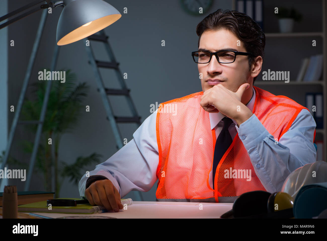 Construction architect working on drawings late at night Stock Photo ...