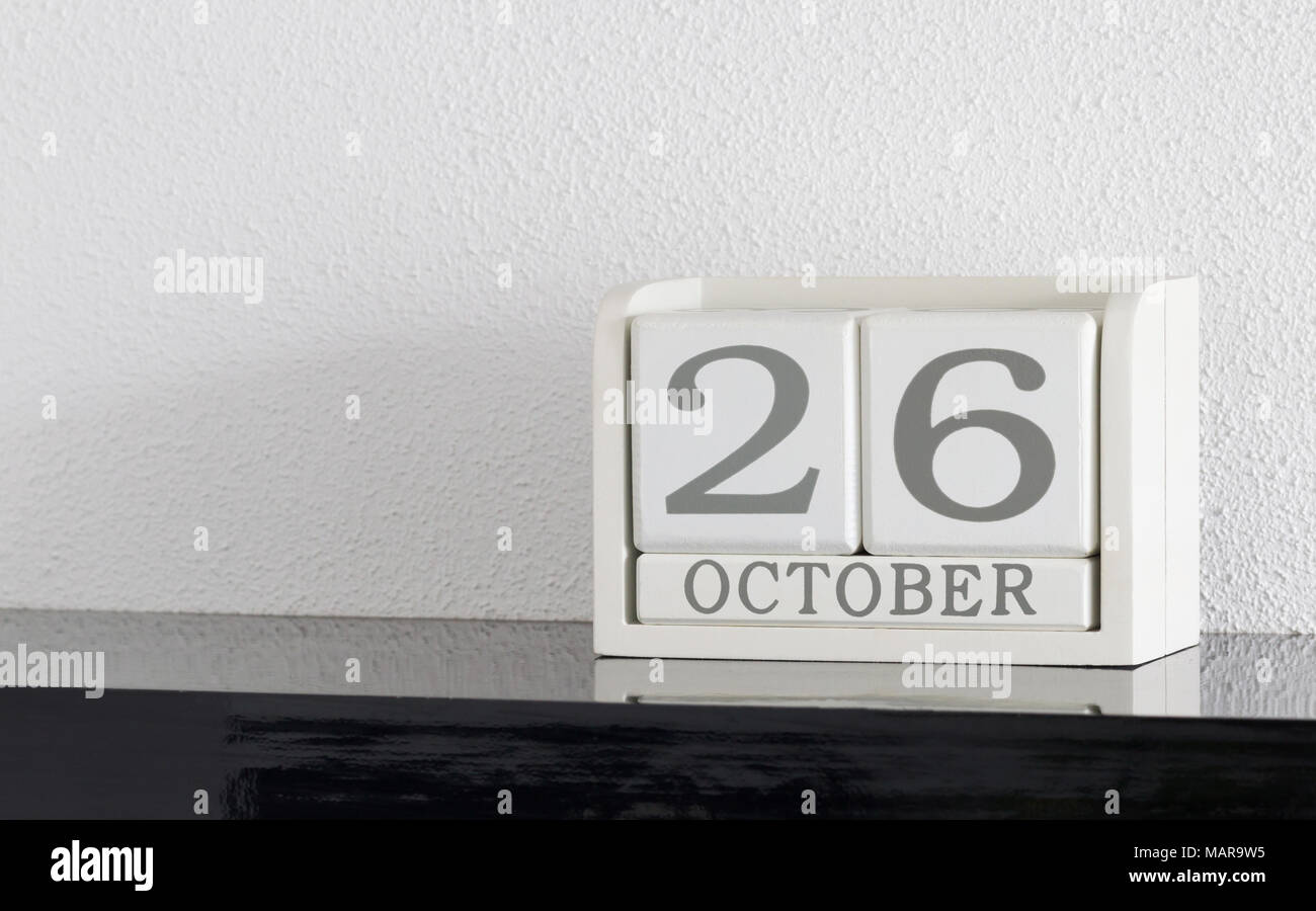 White block calendar present date 26 and month October on white wall ...