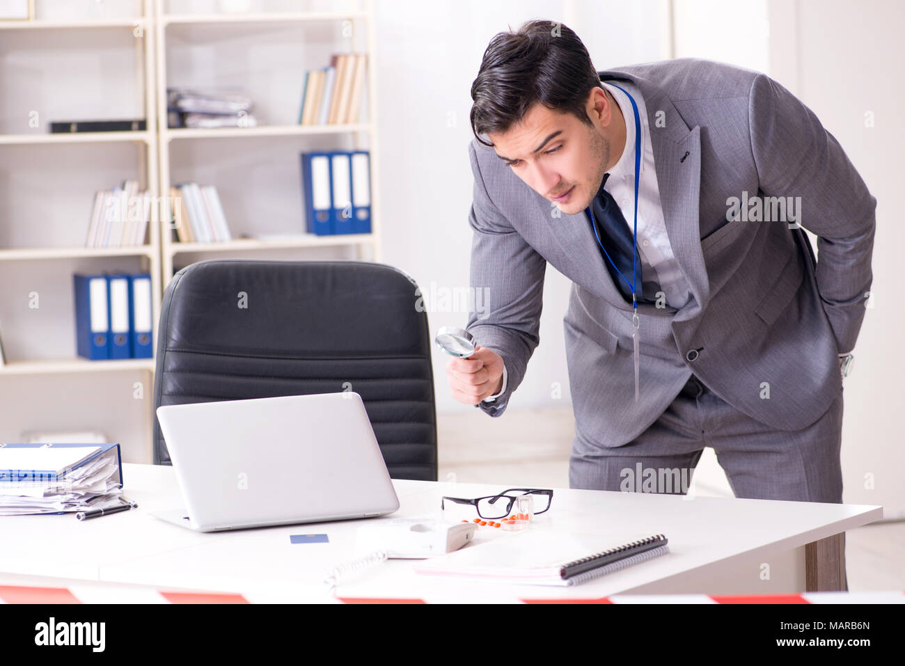 Forensics investigator at the scene of office crime Stock Photo - Alamy
