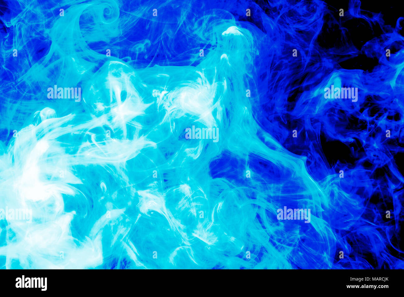 Cloud of blue smoke on a black isolated background. Background from the ...