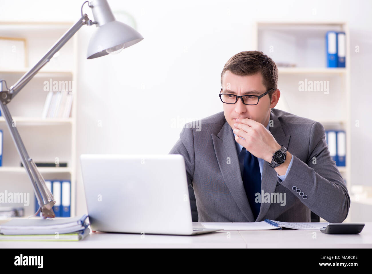 Young handsome businessman employee working in office at desk Stock ...