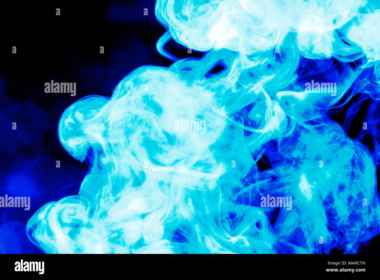 Dense blue smoke on a black isolated background. Background of smoke ...