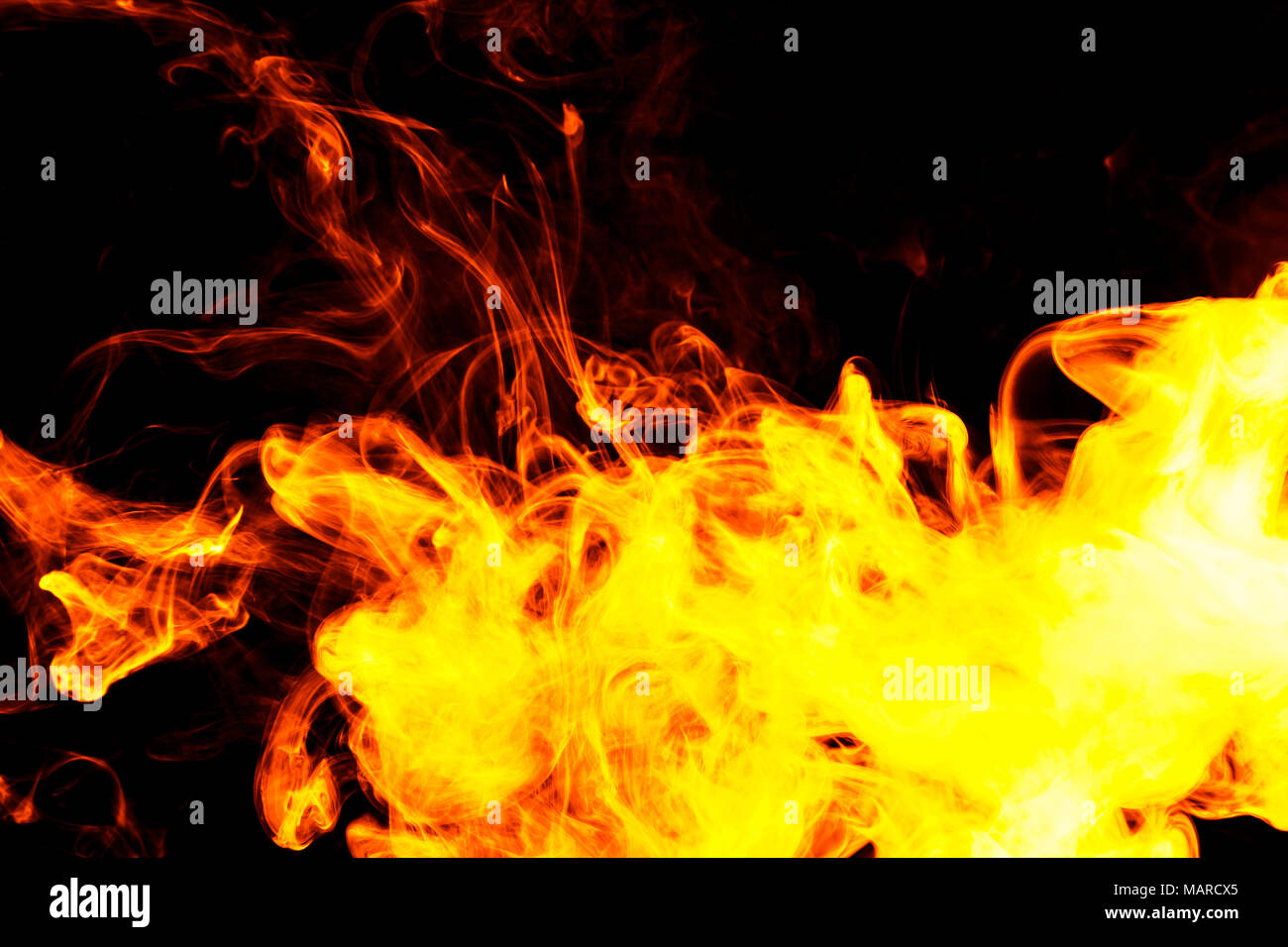 Thick fiary smoke on a black isolated background. Fire flames ...