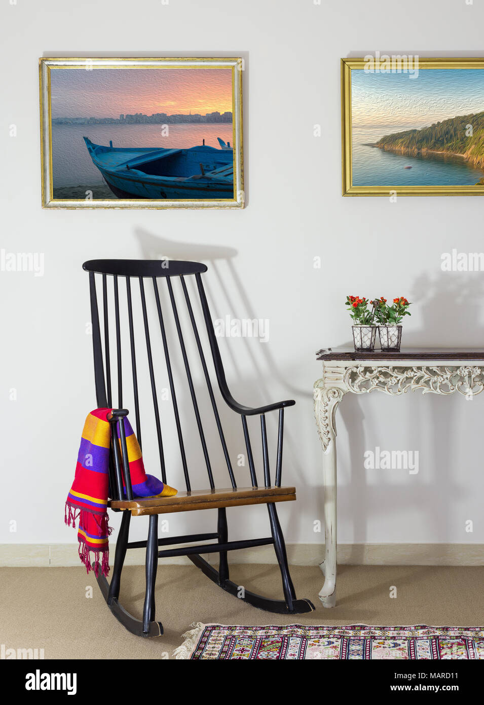 Classic rocking chair and two old books on old style vintage table on ...