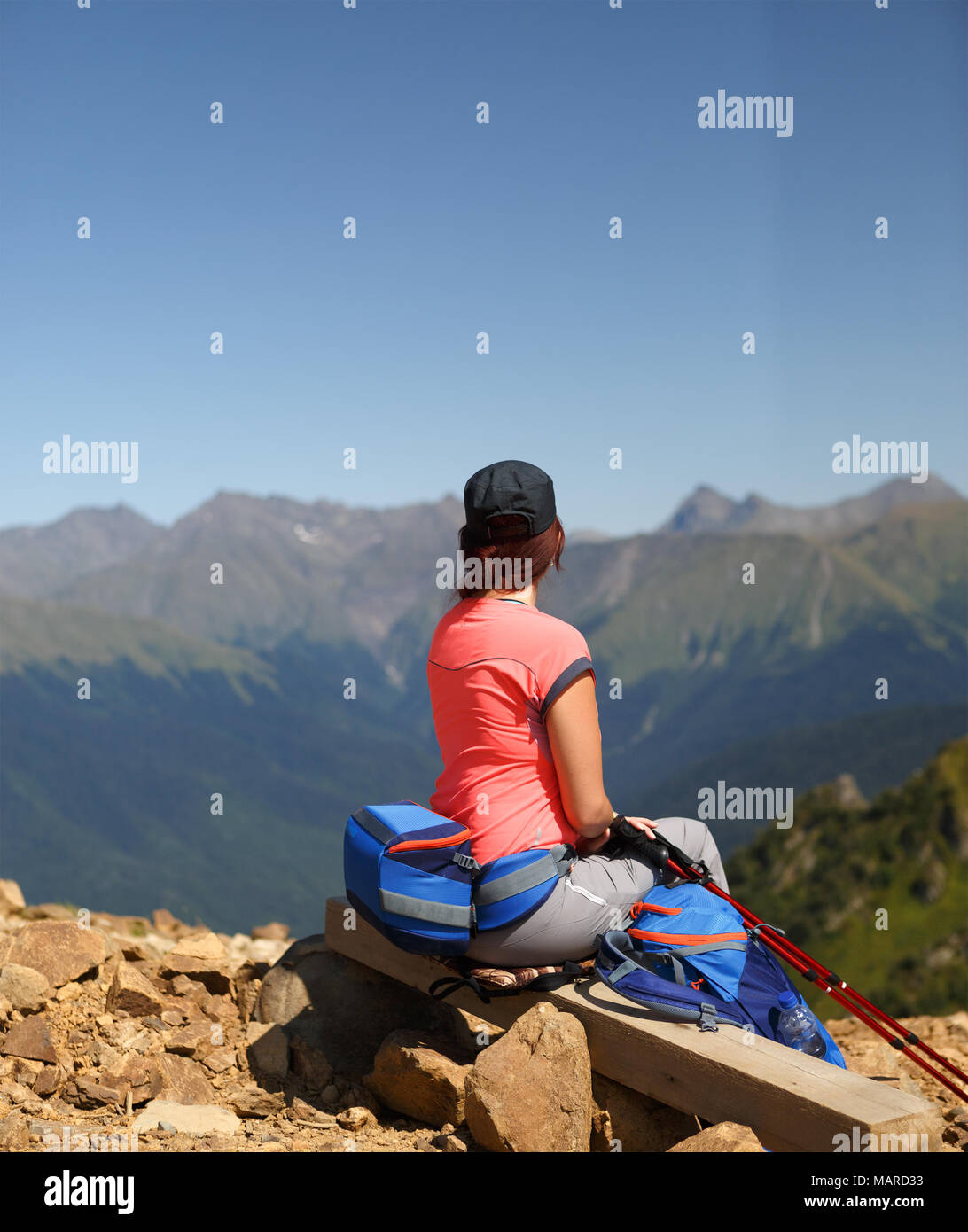 Photo from back of girl with sticks for sporty walk Stock Photo - Alamy