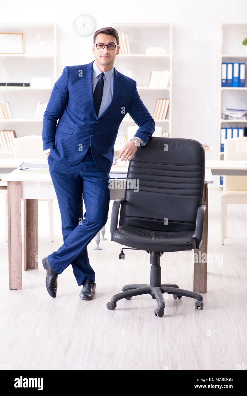 Young handsome businessman employee working in office at desk Stock ...