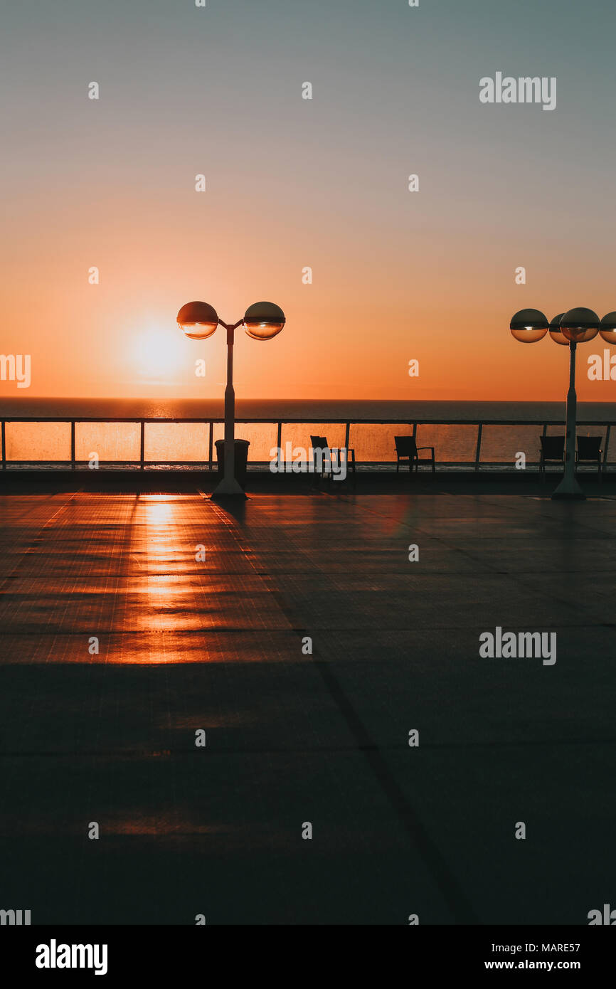 Warm sunset on the ship deck. Reflection of the fading sun on floor ...