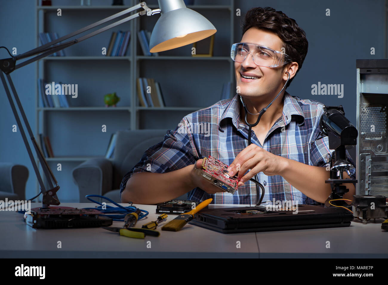 Computer repair concept with man inspecting with stethoscope Stock ...