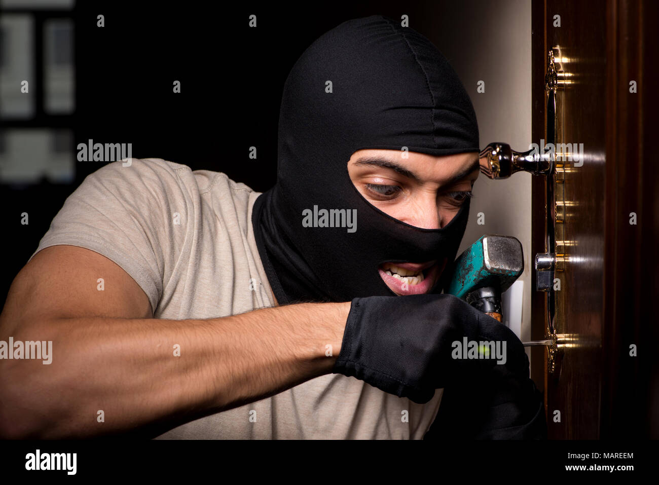 Burglar wearing balaclava mask at crime scene Stock Photo - Alamy