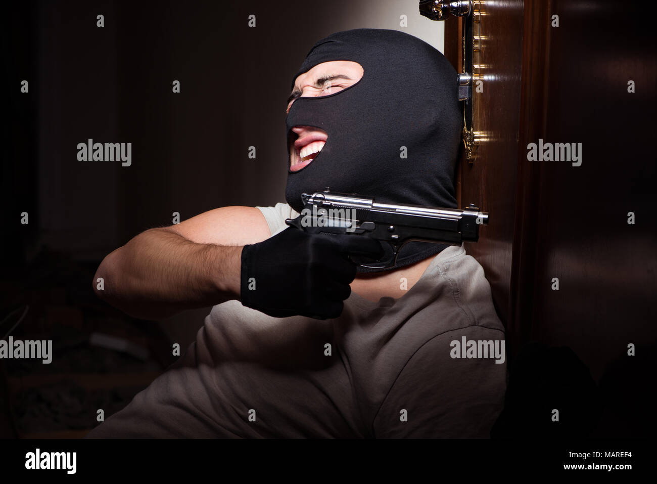 Burglar wearing balaclava mask at crime scene Stock Photo - Alamy